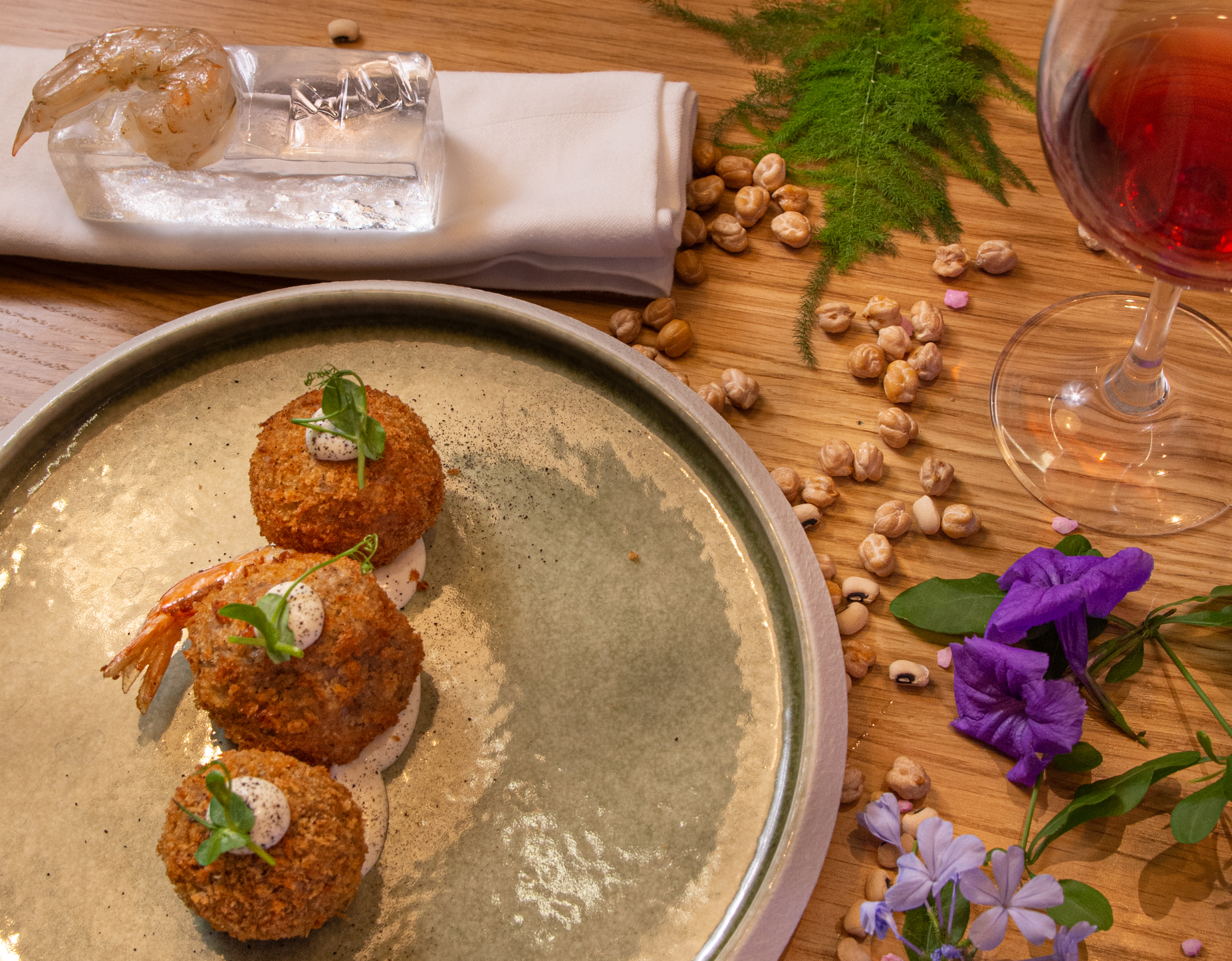 Legume spheres with shrimp and goat cheese cream with a glass of ...